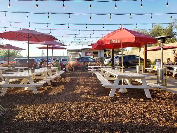 String lights dance overhead as white picnic tables invite you to settle in for a feast. Arizona's perfect evening backdrop for serious BBQ business.
