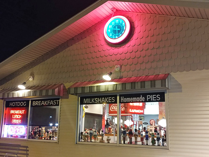 The neon glow of that iconic clock sign beckons like a lighthouse for hungry travelers. Homemade pies advertised right on the window—they know their strengths!