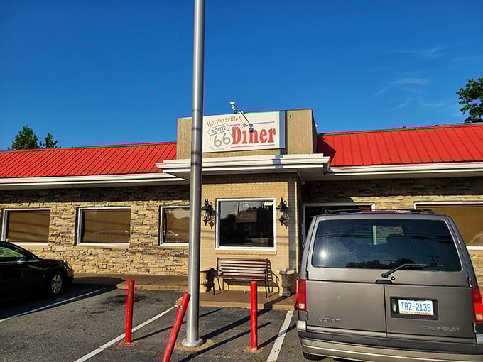 The iconic red roof and stone facade of Route 66 Diner beckons hungry travelers like a comfort food lighthouse in Kernersville's sea of chain restaurants.