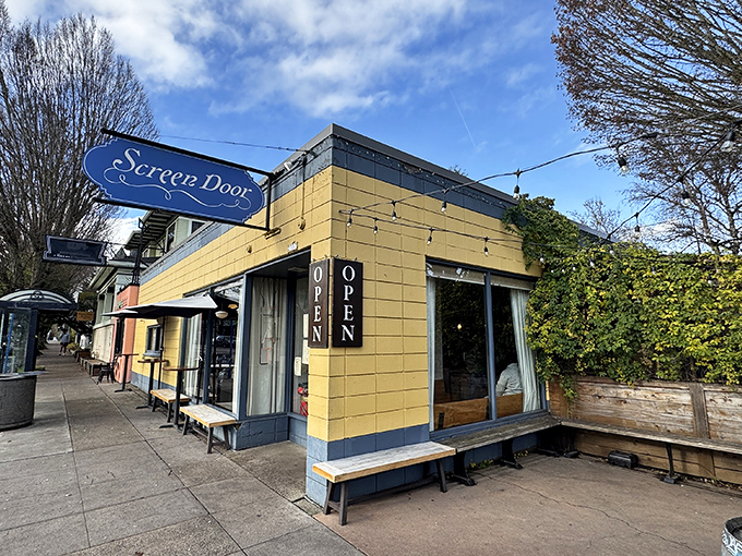 The cheerful yellow exterior of Screen Door Eastside stands like a beacon of Southern comfort in Portland's urban landscape, promising delicious treasures within.