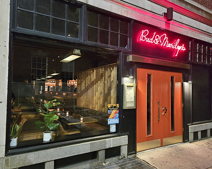 Those iconic red doors aren't just an entrance – they're a portal to comfort food paradise. Bud & Marilyn's neon sign glows like a beacon for hungry Philadelphians.