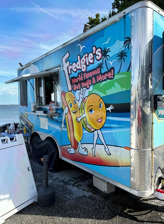 That cheerful blue food truck isn't just transportation – it's a mobile temple of hot dog happiness.