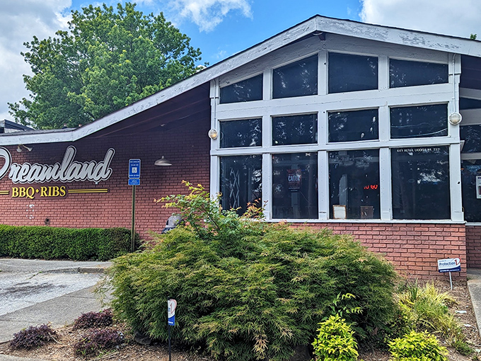 The brick exterior of Dreamland BBQ promises no-frills authenticity. Like a BBQ time machine, this unassuming building houses smoky treasures waiting to be discovered.