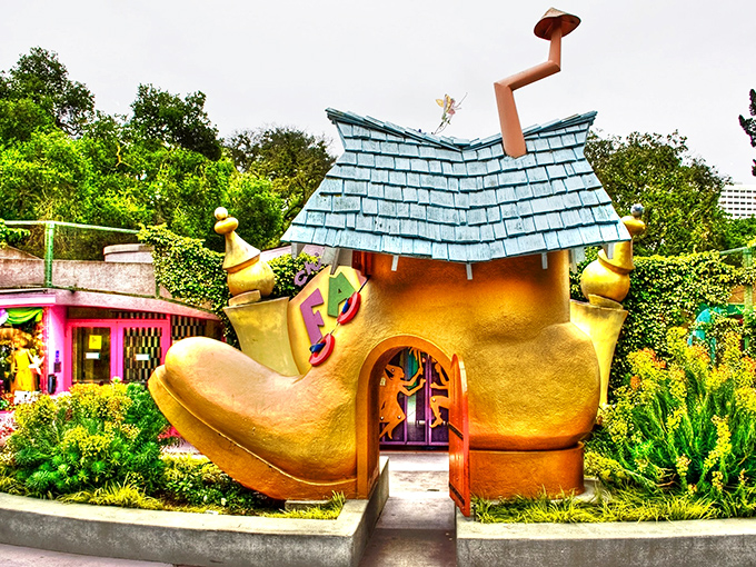 The Old Woman's Shoe House stands like a golden beacon of childhood wonder, complete with teal roof and whimsical charm that defies architectural logic.