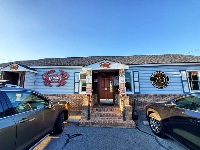 The blue clapboard exterior with giant red crabs isn't subtle advertising—it's a promise of what awaits inside this Delaware seafood sanctuary.