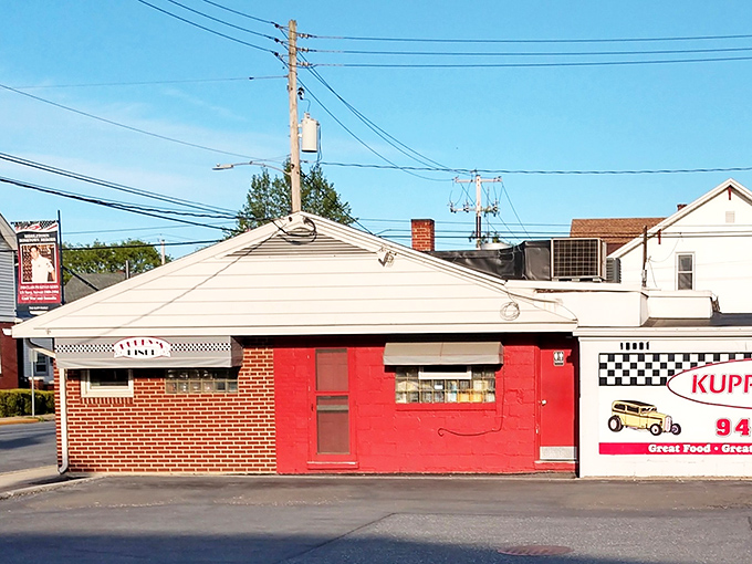 The unassuming brick exterior of Kuppy's Diner might not scream "culinary destination," but that red door is practically a portal to breakfast nirvana.