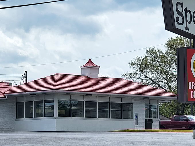 The iconic red-roofed Speck's Drive-In stands like a time capsule of Americana, promising simple pleasures and culinary nostalgia to all who visit.