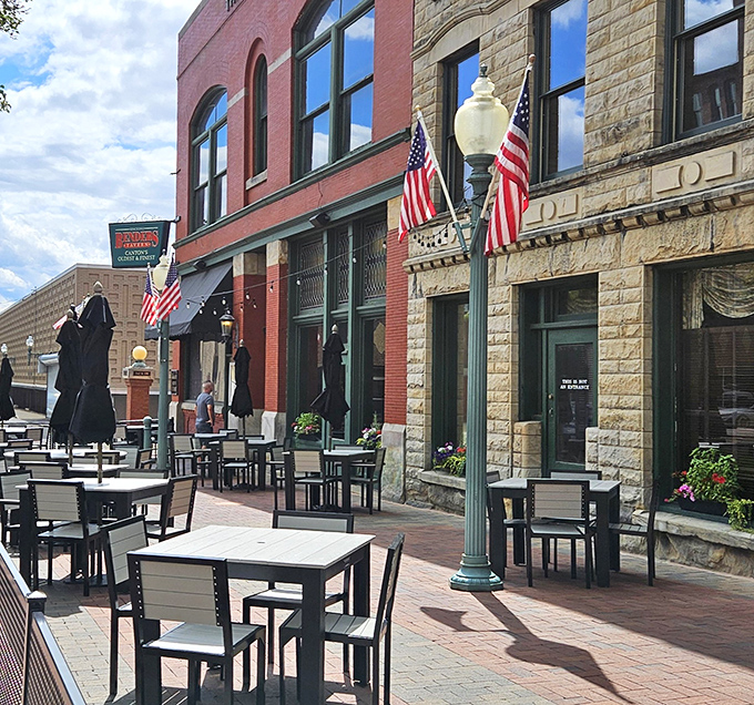 The historic brick façade of Bender's Tavern stands proudly in downtown Canton, where American flags flutter like culinary battle standards over the inviting outdoor seating area.
