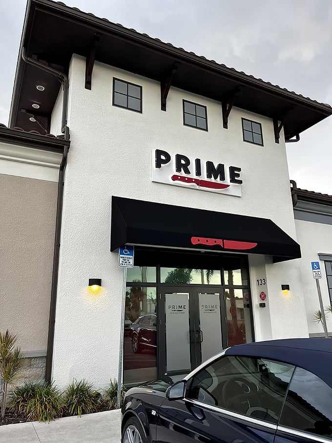 The striking white exterior with its bold red knife logo promises serious business when it comes to steak. This isn't a place that minces words—or meat.