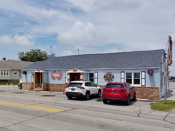 The iconic blue exterior of Sambo's Tavern, where those giant red crab signs aren't just decoration—they're a delicious promise of what awaits inside.