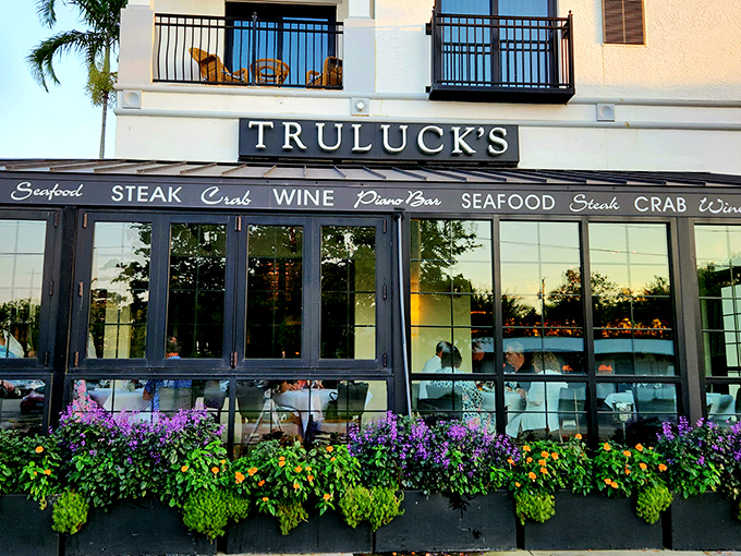Truluck's exterior welcomes you with vibrant flower boxes and elegant windows that offer a tantalizing glimpse of the culinary paradise waiting inside.