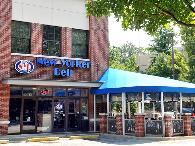 The blue awning and brick facade of Jack's New Yorker Deli stands as a beacon of sandwich salvation in Atlanta's bustling cityscape.