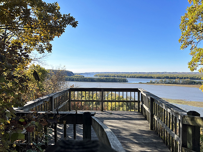 Nature's welcome mat unfurls along this sun-dappled trail, where the Mississippi River peeks through the trees like a shy neighbor wondering if you brought snacks.