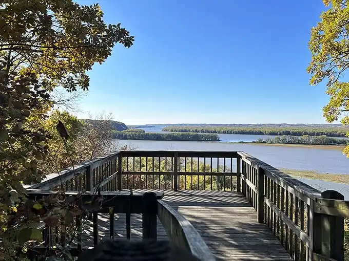 Nature's welcome mat unfurls along this sun-dappled trail, where the Mississippi River peeks through the trees like a shy neighbor wondering if you brought snacks.