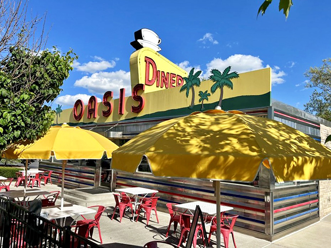 The sunshine-yellow facade of Oasis Diner beckons like a time machine disguised as a roadside attraction. Those palm trees on the sign? Pure Midwestern optimism.