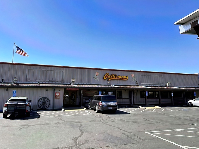 The iconic Cattlemens exterior welcomes hungry travelers with its Western charm and neon cowboy boots. This isn't just dinner—it's a destination.
