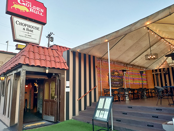The iconic red sign of The Golden Bull stands as a beacon for hungry souls seeking refuge in Santa Monica Canyon's culinary landscape.