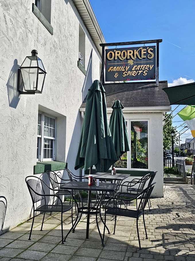 The welcoming white exterior of O'Rorke's, where outdoor tables await under folded umbrellas—a perfect spot for people-watching while savoring Gettysburg's flavors.