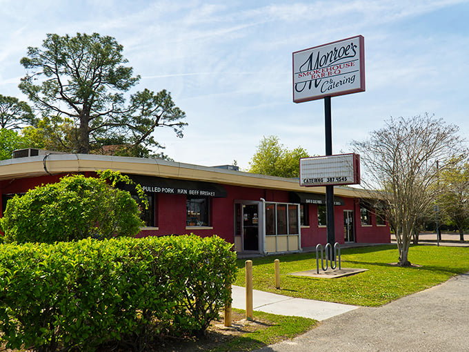 The burgundy building beckons like a smoke signal to barbecue pilgrims. Monroe's modest exterior hides Jacksonville's worst-kept secret—extraordinary smoked meats await inside.