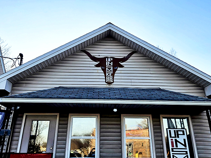 The longhorn logo above this unassuming tan house is like a smoke signal to barbecue lovers – something magical is happening inside Up In Smoke BBQ.