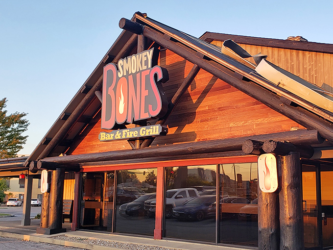 The rustic log cabin exterior beckons like a barbecue mirage in the prairie landscape. This isn't just a restaurant—it's a smoke signal to hungry travelers.