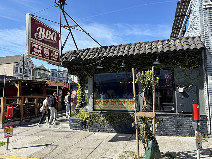 The charming exterior of 4505 Burgers & BBQ beckons with its vintage sign and vine-covered facade—a carnivore's oasis in San Francisco's urban landscape.