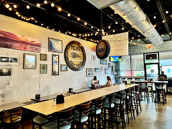 String lights dance above Pelon's communal table, where surf art and coastal vibes transport diners straight to Baja's sunny shores.