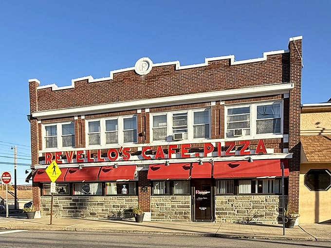 The brick facade and bright red awnings of Revello's stand like a beacon of pizza promise on Old Forge's main drag, beckoning hungry travelers from miles around.