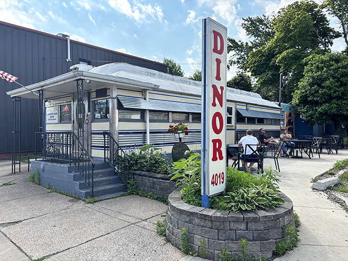 The gleaming silver exterior of Lawrence Park Dinor stands like a time machine in Erie, beckoning hungry travelers with its iconic vertical sign and promise of comfort food perfection.