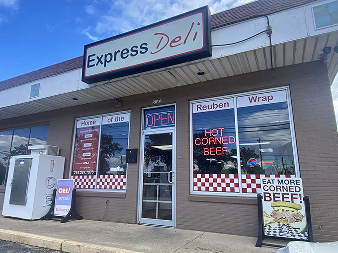 The unassuming storefront with its glowing "HOT CORNED BEEF" sign is like a lighthouse for sandwich lovers lost in a sea of mediocre lunch options.