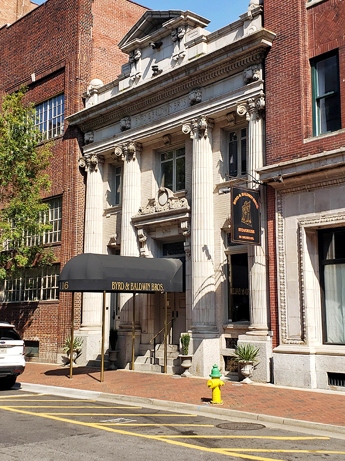 The grand neoclassical façade of Byrd & Baldwin Bros Steakhouse glows like a culinary temple at night, beckoning hungry pilgrims with promises of carnivorous delights.