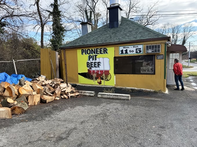 The humble yellow shack that houses Pioneer Pit Beef might not look like much, but that woodpile outside isn't decorative—it's the secret to Maryland's most magnificent meat.