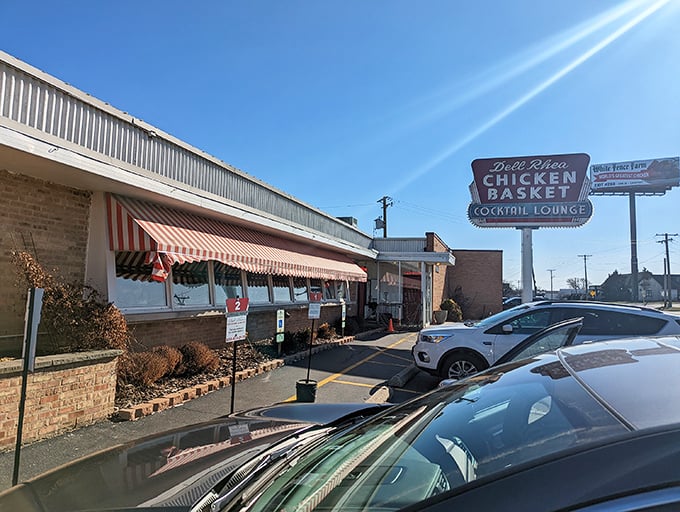 The iconic Dell Rhea's Chicken Basket sign stands like a beacon for hungry travelers, promising Route 66 comfort that's outlasted eight presidential administrations.