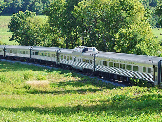 Silver carriages gliding through emerald Tennessee countryside – a moving postcard that makes you forget the modern world exists.