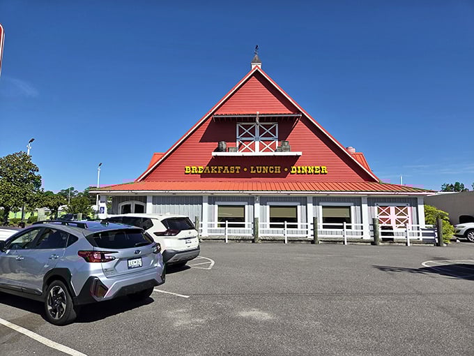 The iconic red barn-shaped building stands proudly against a blue sky, promising comfort food that feels like coming home.