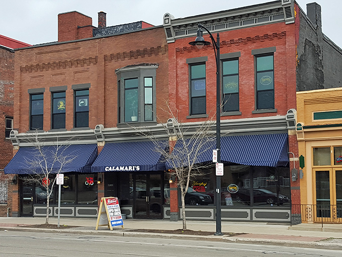 The brick facade of Calamari's Squid Row stands proudly against Erie's blue sky, a culinary lighthouse beckoning hungry travelers to its doorstep.