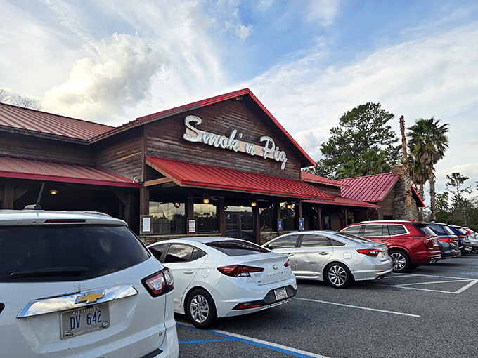 The sunset glow behind Smokin' Pig's rustic wooden exterior and signature red roof feels like nature's way of highlighting where dinner should happen tonight.