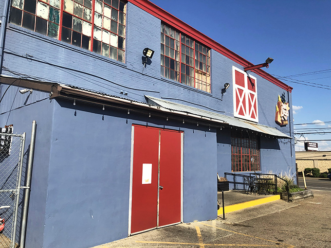 The blue barn-like exterior of Sweet Lucy's stands as a beacon of barbecue hope in Northeast Philly—architectural proof that great BBQ needs no fancy facade.