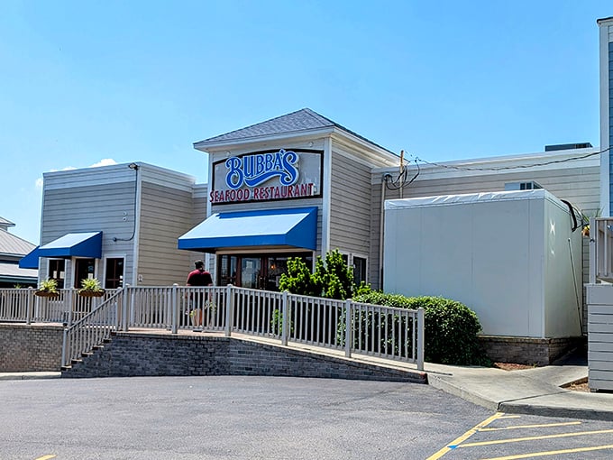Bubba's welcomes you with that perfect coastal charm – a blue-awninged beacon of seafood promise against a golden Virginia Beach sunset.