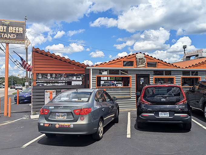 The iconic orange and gray exterior of The Root Beer Stand stands as a time capsule of Americana, beckoning hungry travelers with its vintage neon sign.