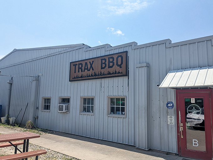 The unassuming exterior of Trax BBQ proves once again that the best barbecue joints often hide in plain sight, like culinary speakeasies of smoke and meat.