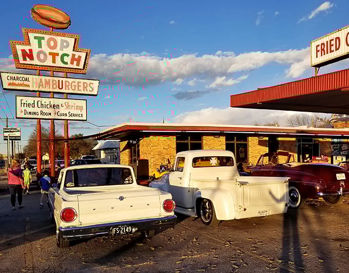 That iconic neon sign isn't just advertising—it's a time portal to when drive-ins ruled and chrome-trimmed cars were kings of the road.