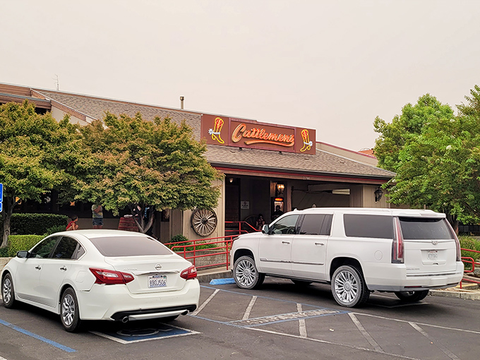 The iconic Cattlemens exterior beckons hungry travelers with its Western charm and cowboy boot signage—a beacon of beef in Redding's landscape.