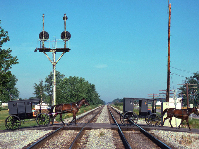 Where worlds collide! Amish buggies and railroad tracks create the perfect metaphor for Nappanee's unique blend of traditional values and modern convenience.