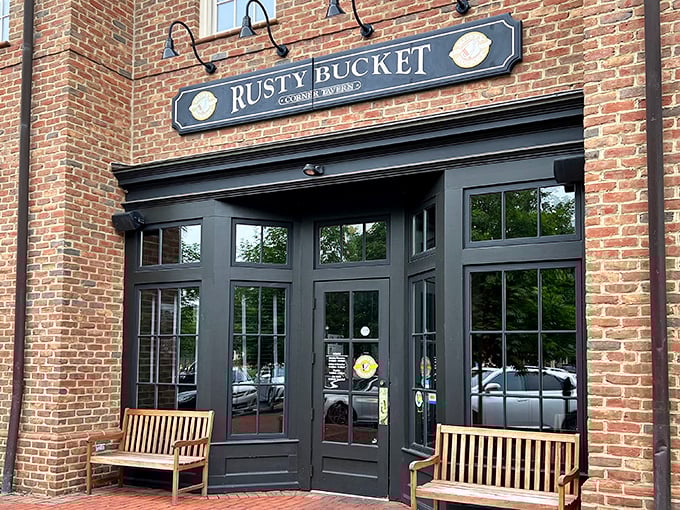 The warm brick exterior of Rusty Bucket welcomes you like an old friend who's genuinely happy to see you. Those benches practically whisper, "Come on in, the comfort food's fine."