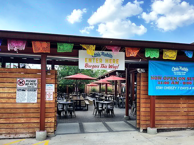 Colorful papel picado banners welcome you to burger paradise. The "Enter Here" sign might as well say "Abandon Diet All Ye Who Enter."