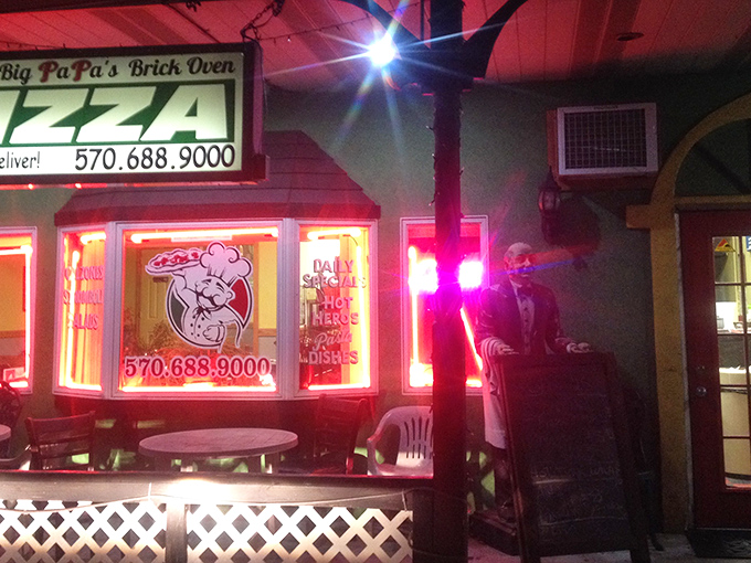 The neon glow of Big PaPa's at night isn't just a beacon for hungry travelers—it's a promise of brick oven perfection waiting inside.