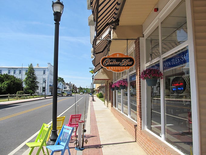 Colorful chairs line Commerce Street outside The Chatter Box Café, where small-town charm meets morning coffee rituals in Harrington's walkable downtown.