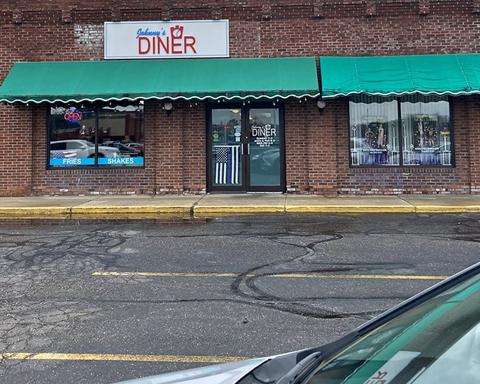 Johnny's Diner announces itself with understated charm – a brick facade, green awnings, and the promise of comfort food that'll make your day infinitely better.