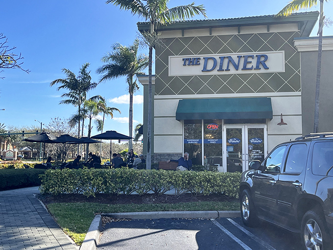 Palm trees standing guard outside The Diner like tropical maître d's welcoming you to breakfast paradise in Boynton Beach.
